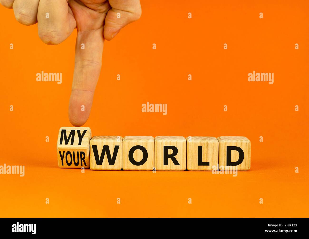 My or your world symbol. Businessman turns wooden cubes and changes ...