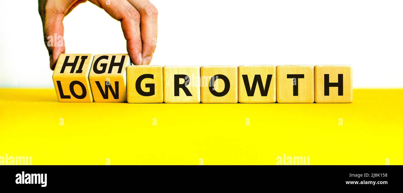 High or low growth symbol. Businessman turns wooden cubes and changes ...