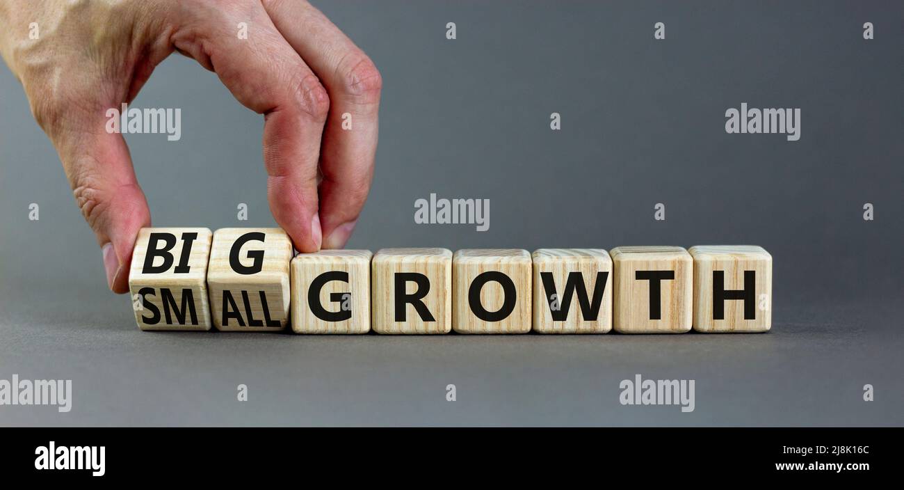 Big or small growth symbol. Businessman turns wooden cubes and changes ...
