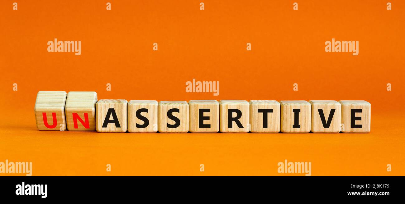 Assertive or unassertive symbol. Turned wooden cubes and changed ... Assertive or unassertive symbol. Turned wooden cubes and changed ...