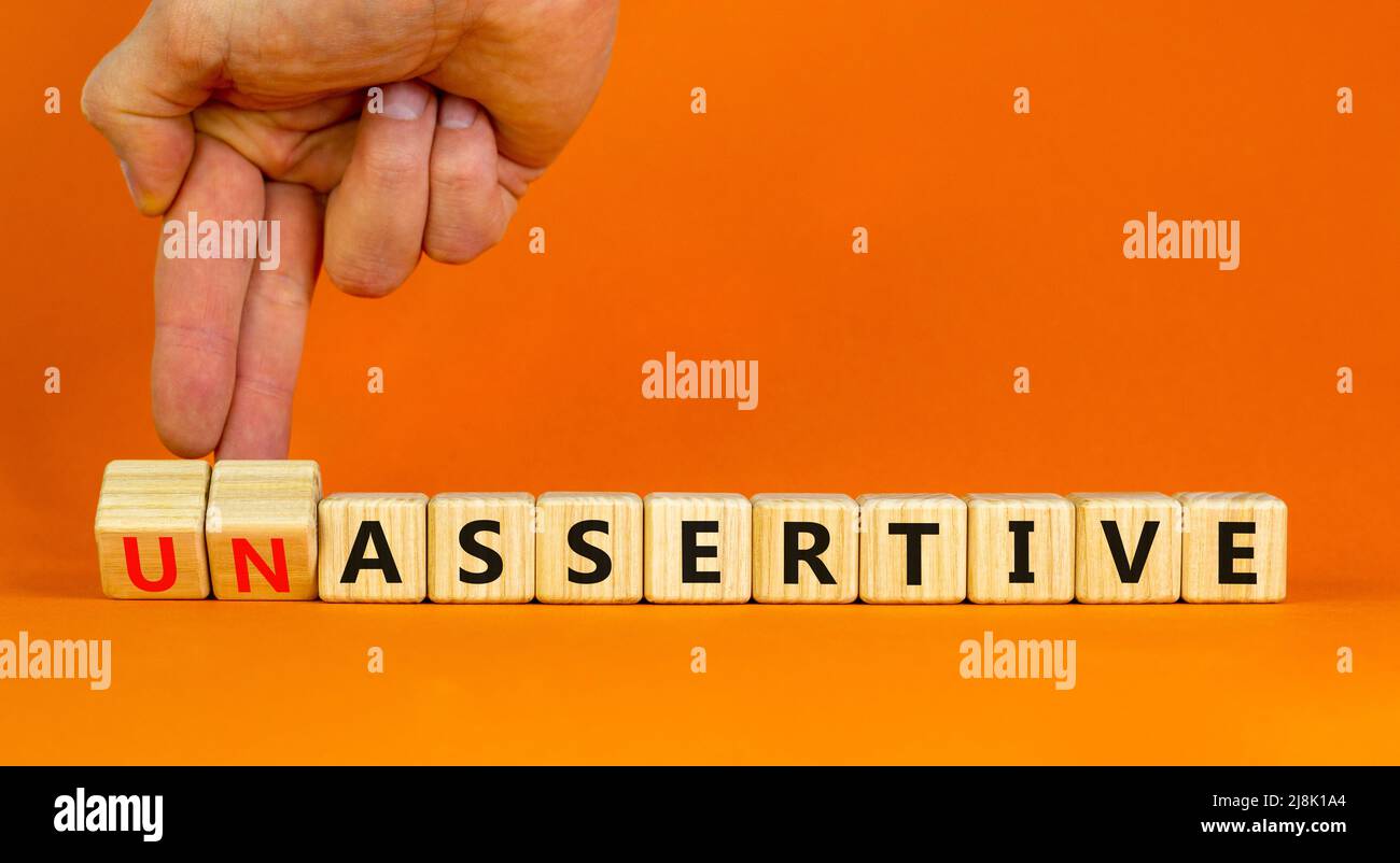 Assertive or unassertive symbol. Businessman turns wooden cubes and ...