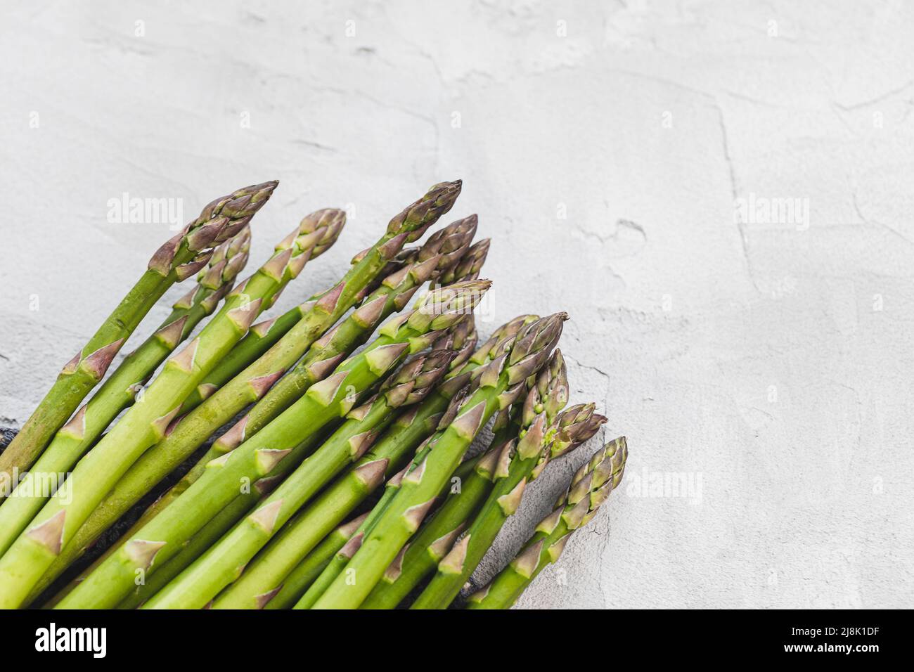 Fresh raw green asparagus spears on gray background. Healthy greens ...