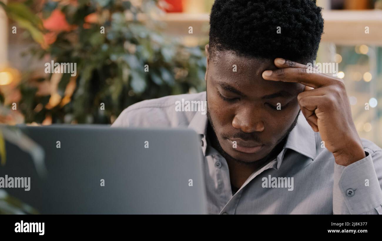 Close-up young male businessman looking at laptop screen receiving ...