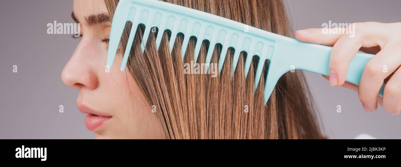 Close up woman combing hair. Hair Care. Beautiful brunette woman ...