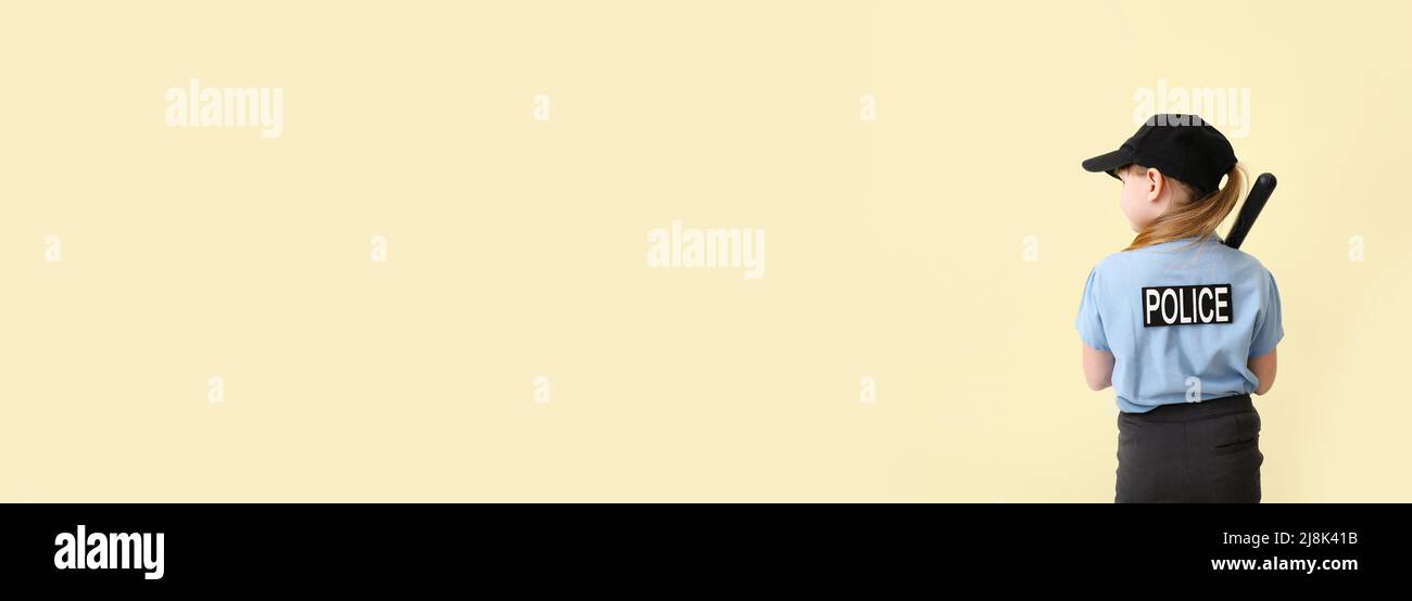 Cute little police officer on light background with space for text ...