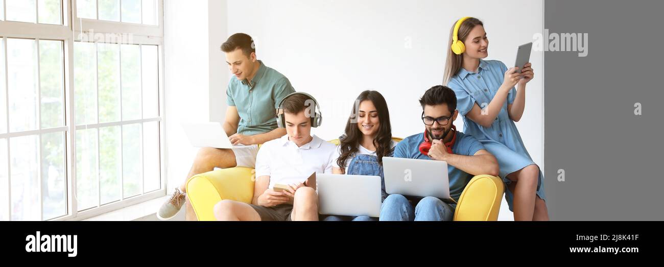 Students with modern devices studying together at home Stock Photo - Alamy