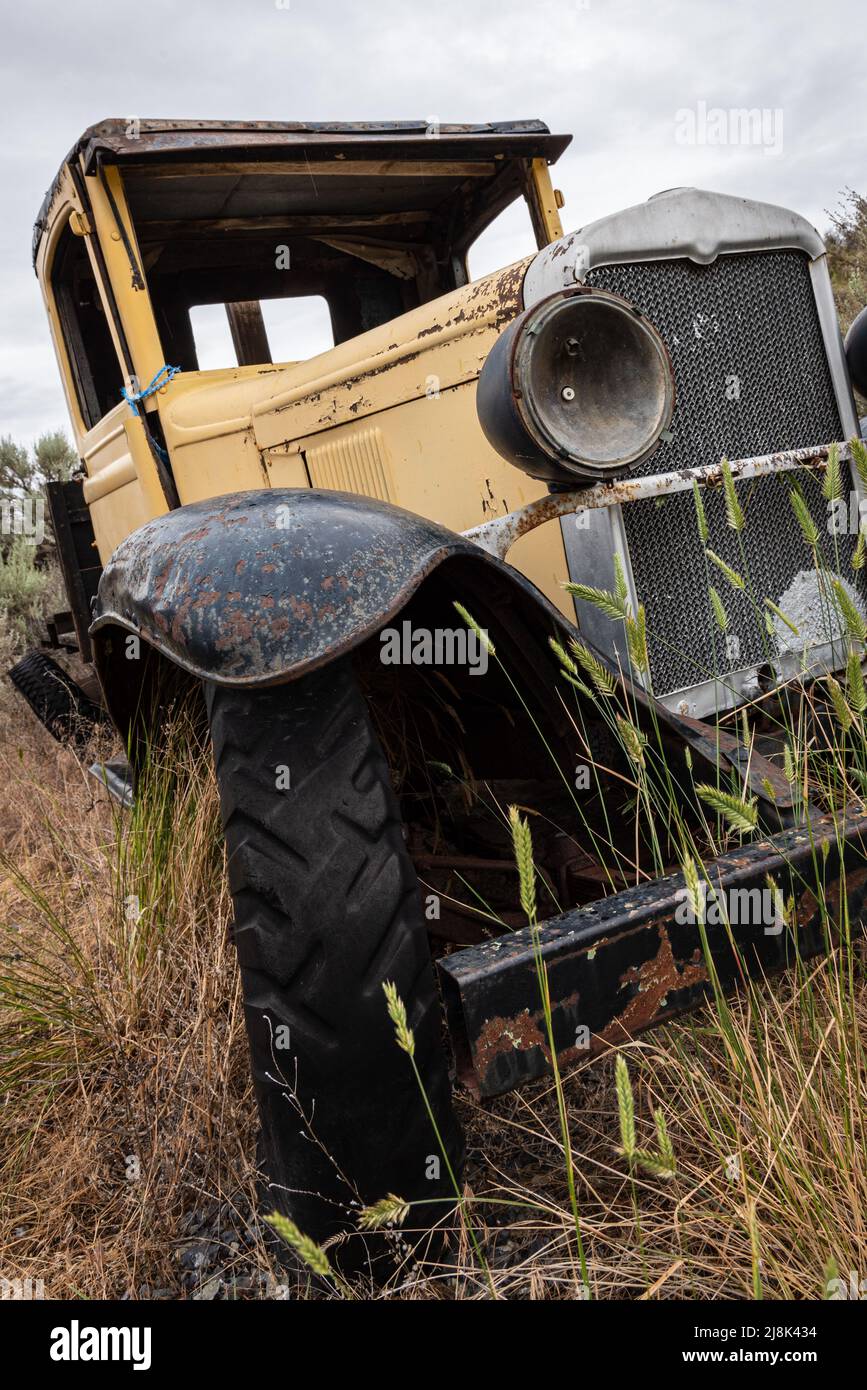 Old rusty antique car in an abandoned field Stock Photo - Alamy