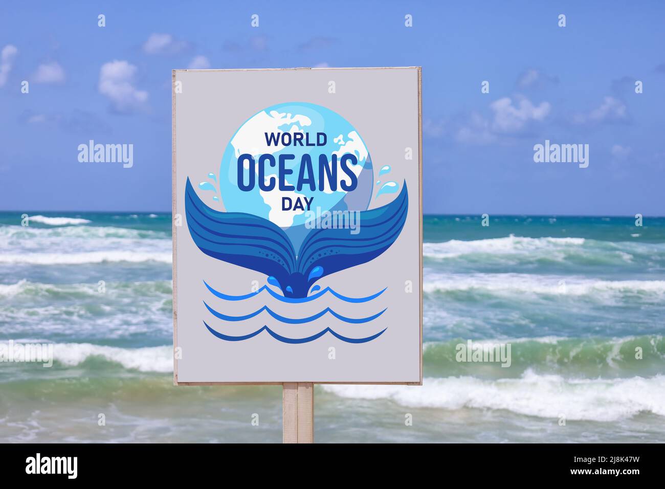 Board with poster for World Ocean Day on beach Stock Photo - Alamy