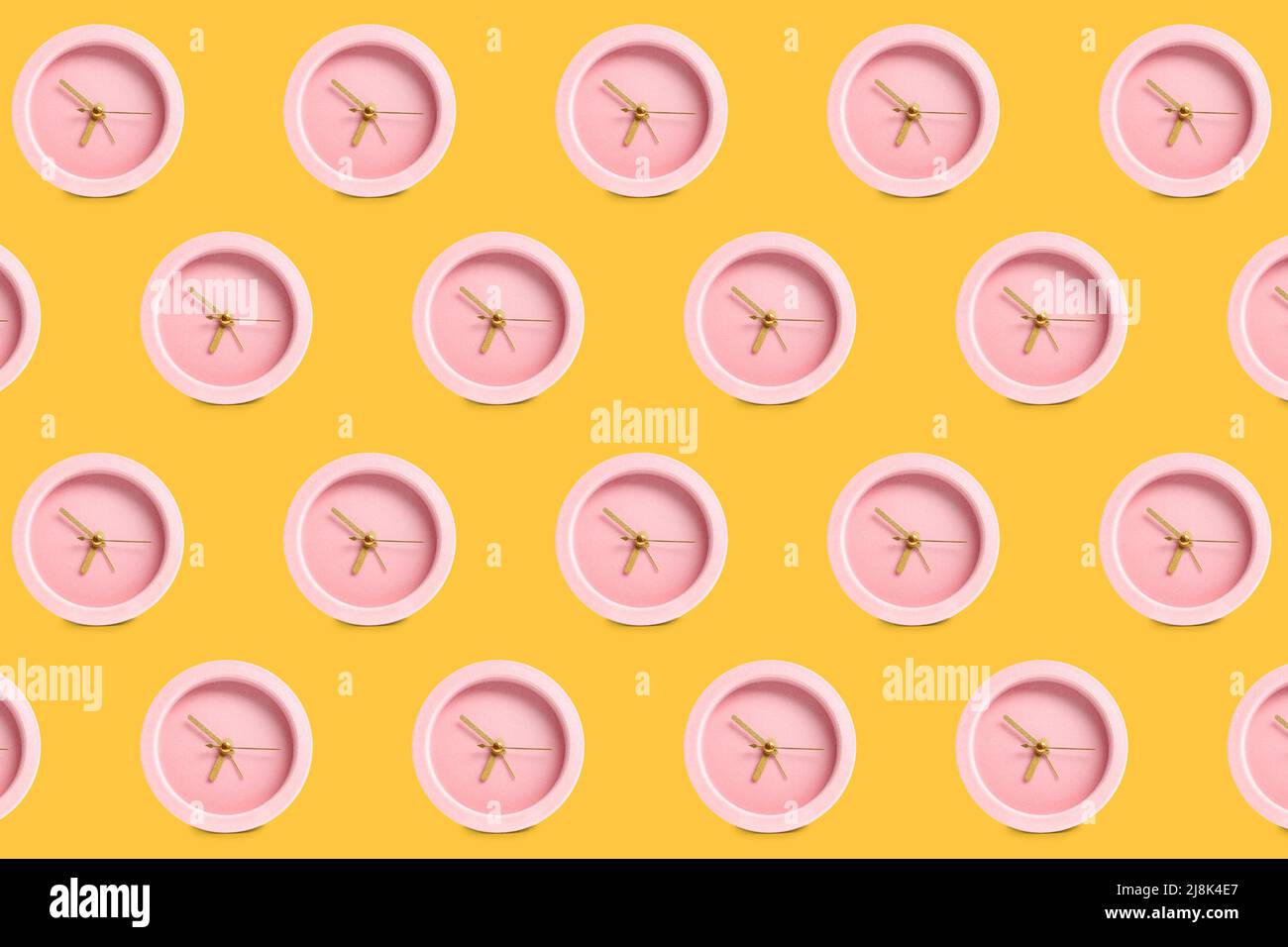 Many clocks on yellow background. Pattern for design Stock Photo - Alamy