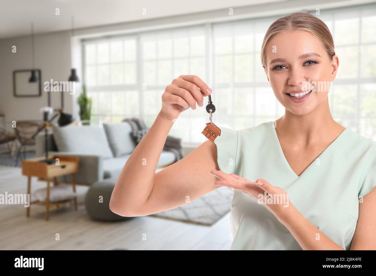 Happy young woman with key in her new house Stock Photo - Alamy