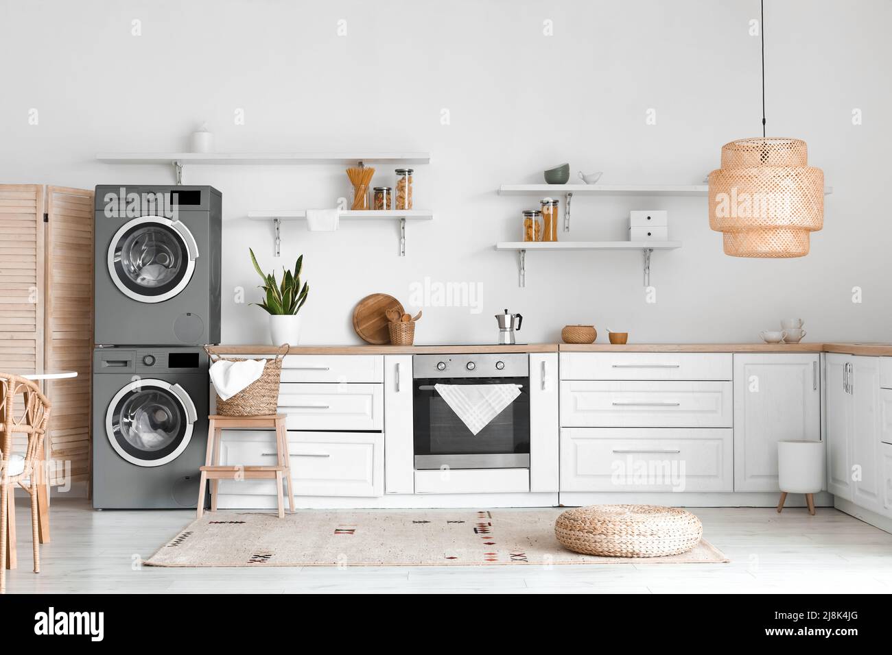 Interior of light kitchen with two washing machines Stock Photo - Alamy