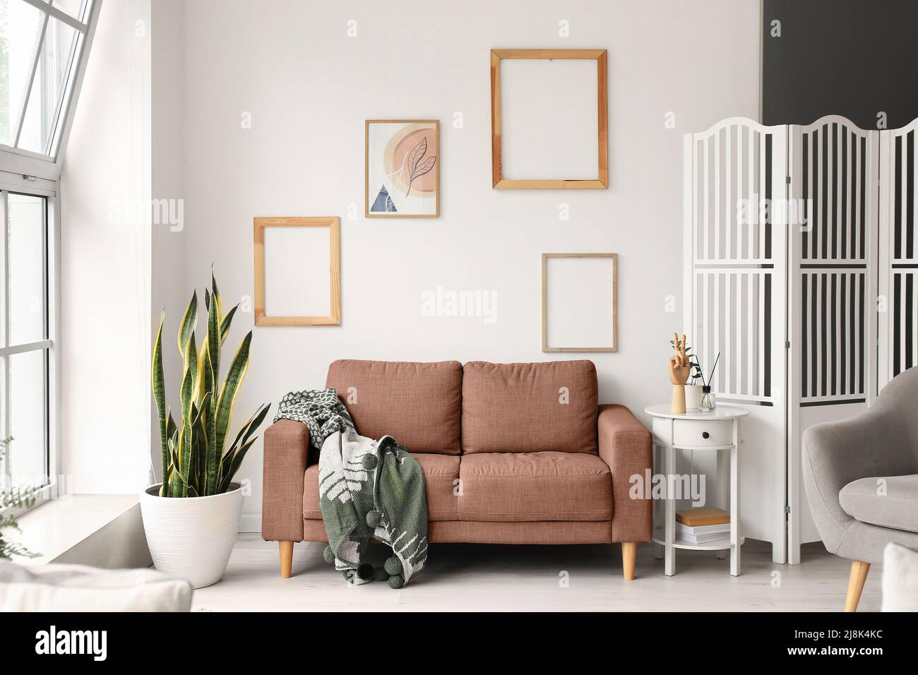 Interior of modern room with sofa and folding screen Stock Photo - Alamy