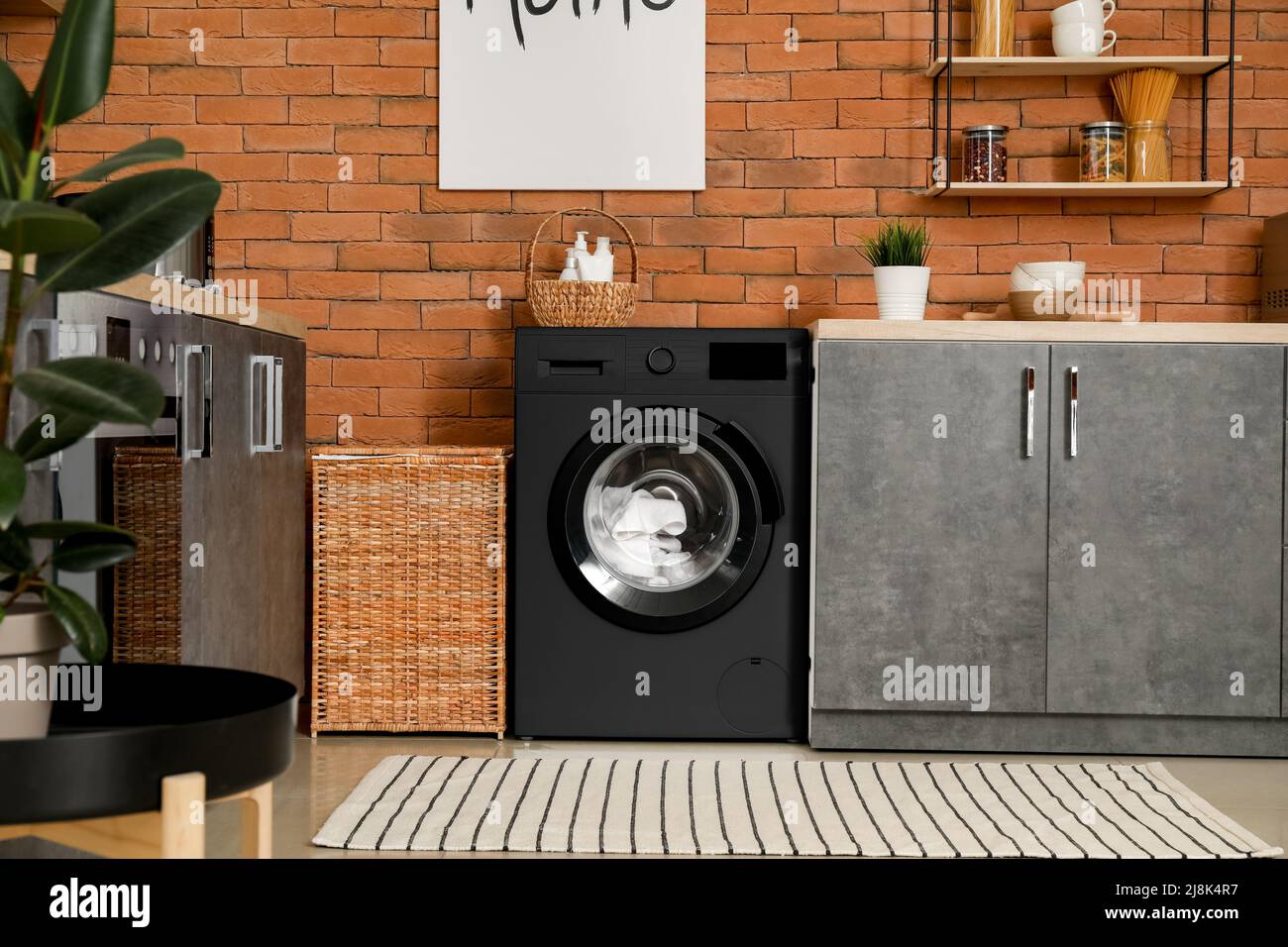 Interior of kitchen with modern washing machine Stock Photo - Alamy
