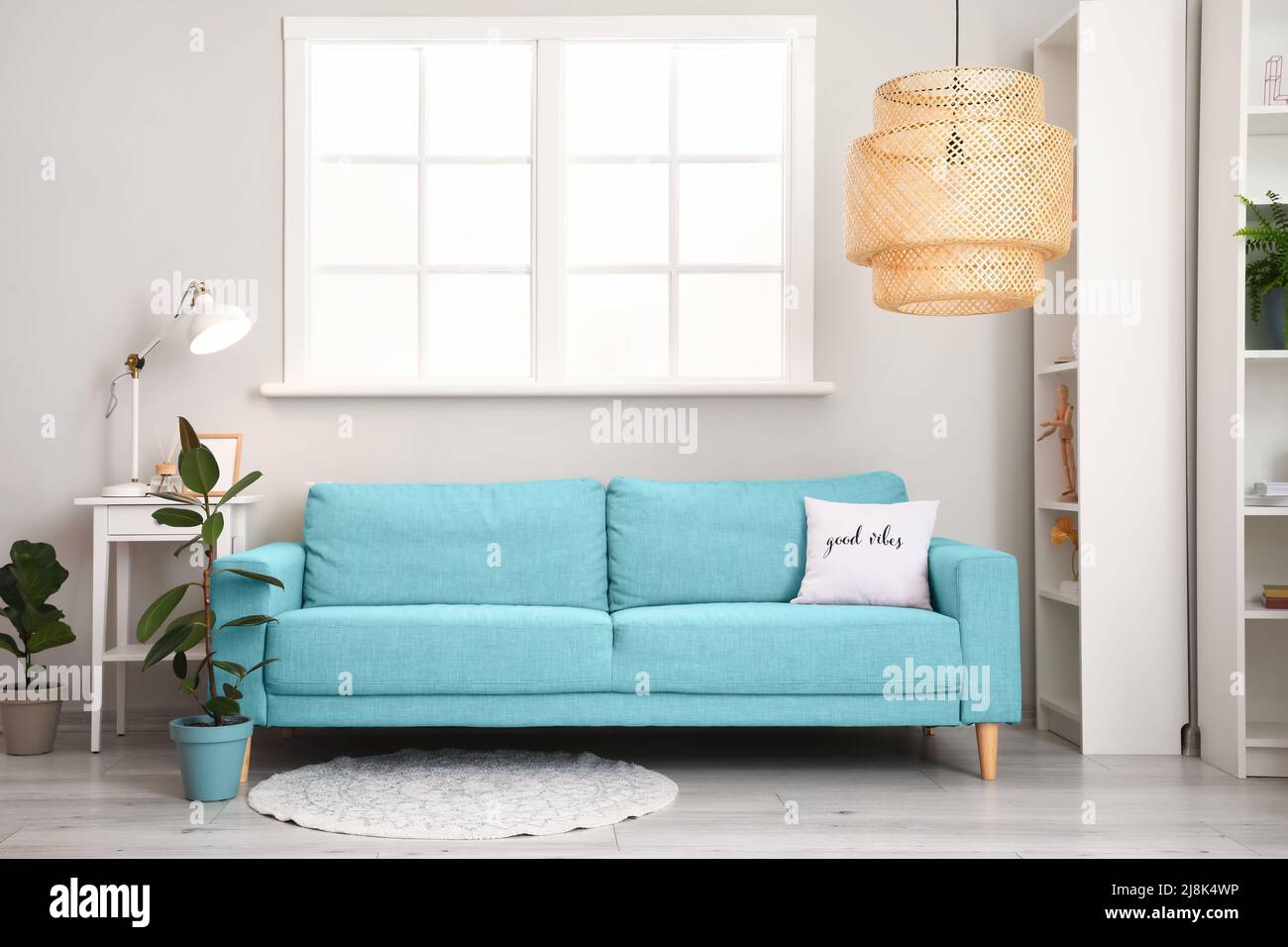Interior of modern living room with blue sofa near window Stock Photo ...
