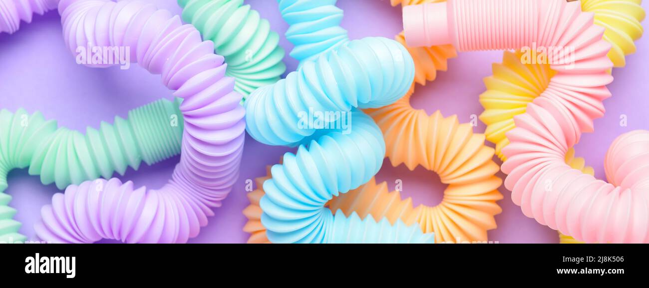 Different colorful Pop Tubes on lilac background. Banner for design ...