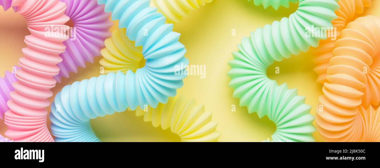 Different colorful Pop Tubes on yellow background. Banner for design ...