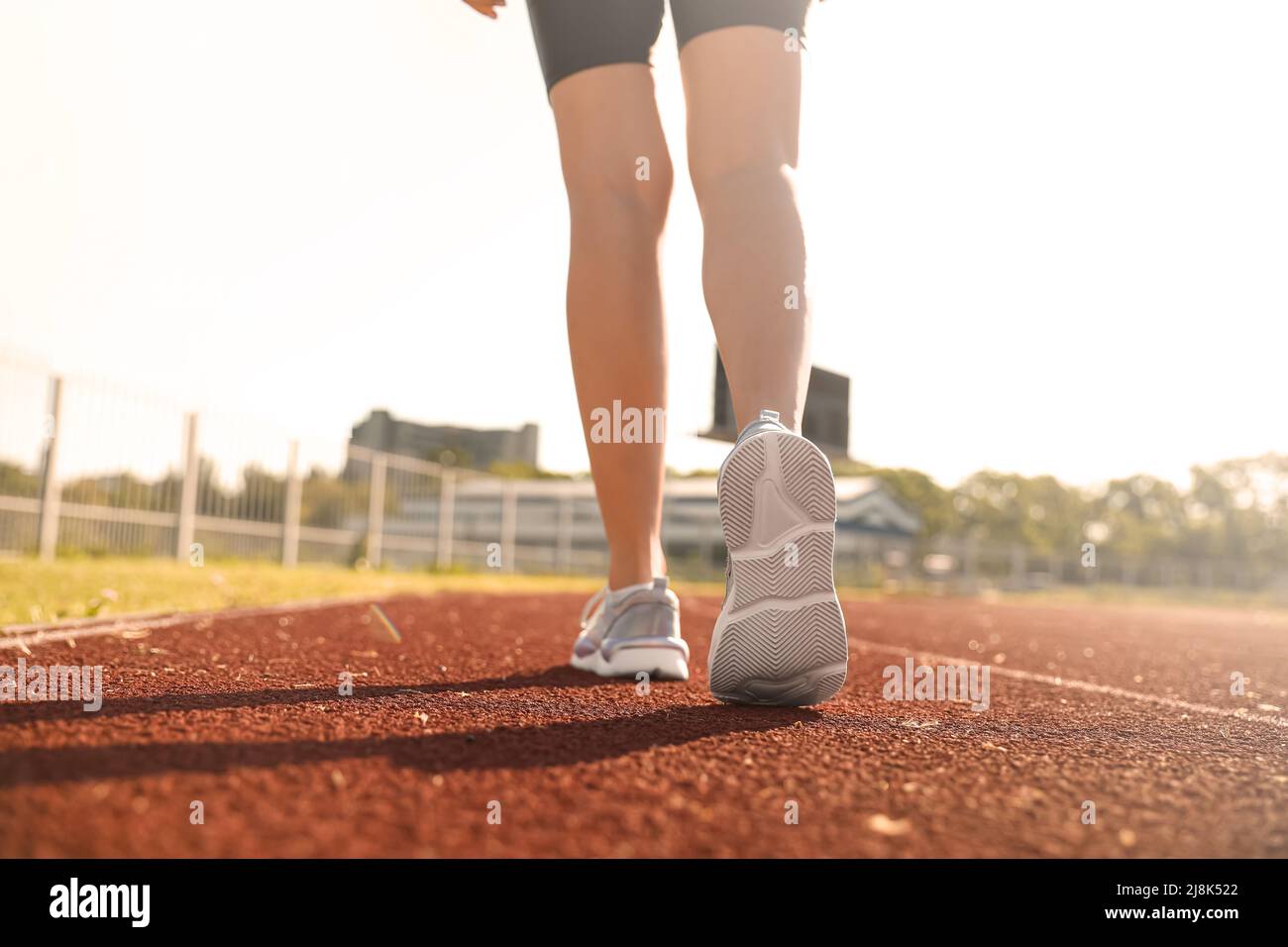 Legs of sporty female runner in the stadium Stock Photo - Alamy