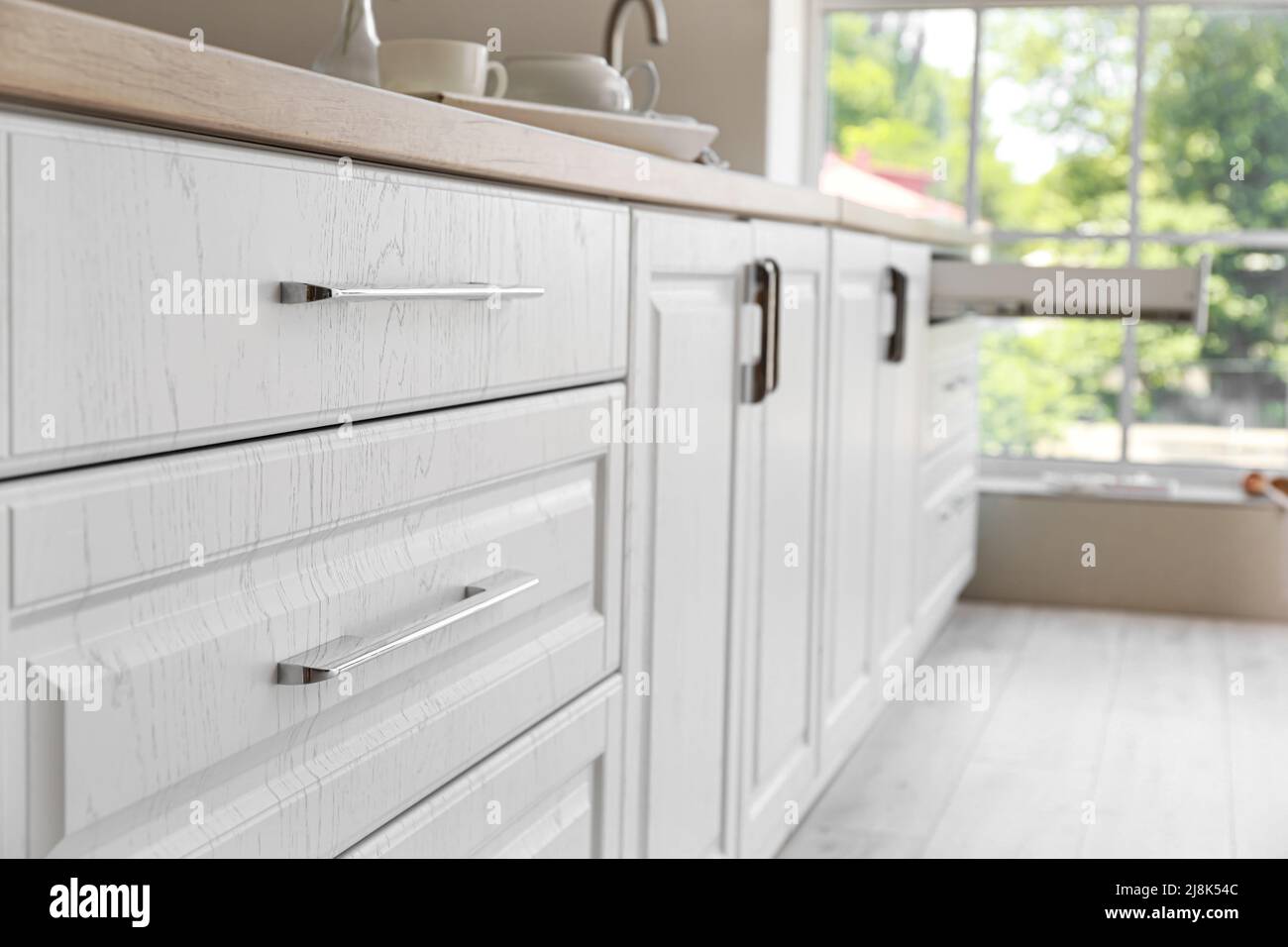 White kitchen drawers in modern room, closeup Stock Photo - Alamy