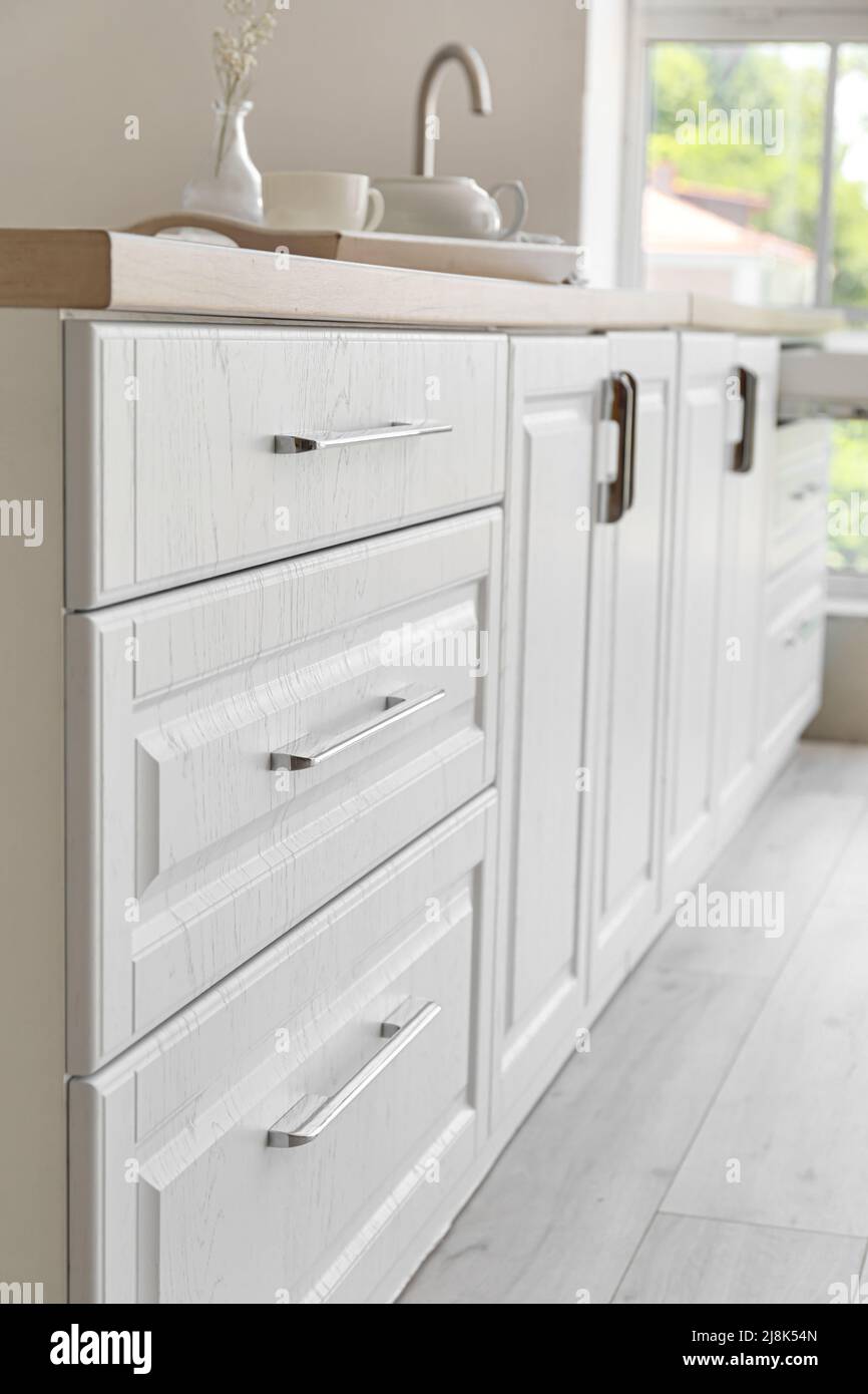 White kitchen drawers in modern room Stock Photo - Alamy