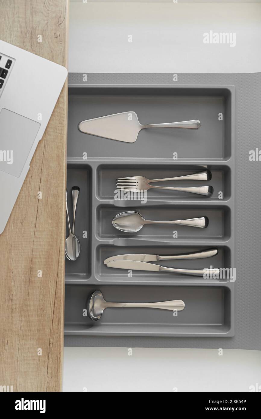 Open drawer with silver cutlery in modern kitchen Stock Photo - Alamy