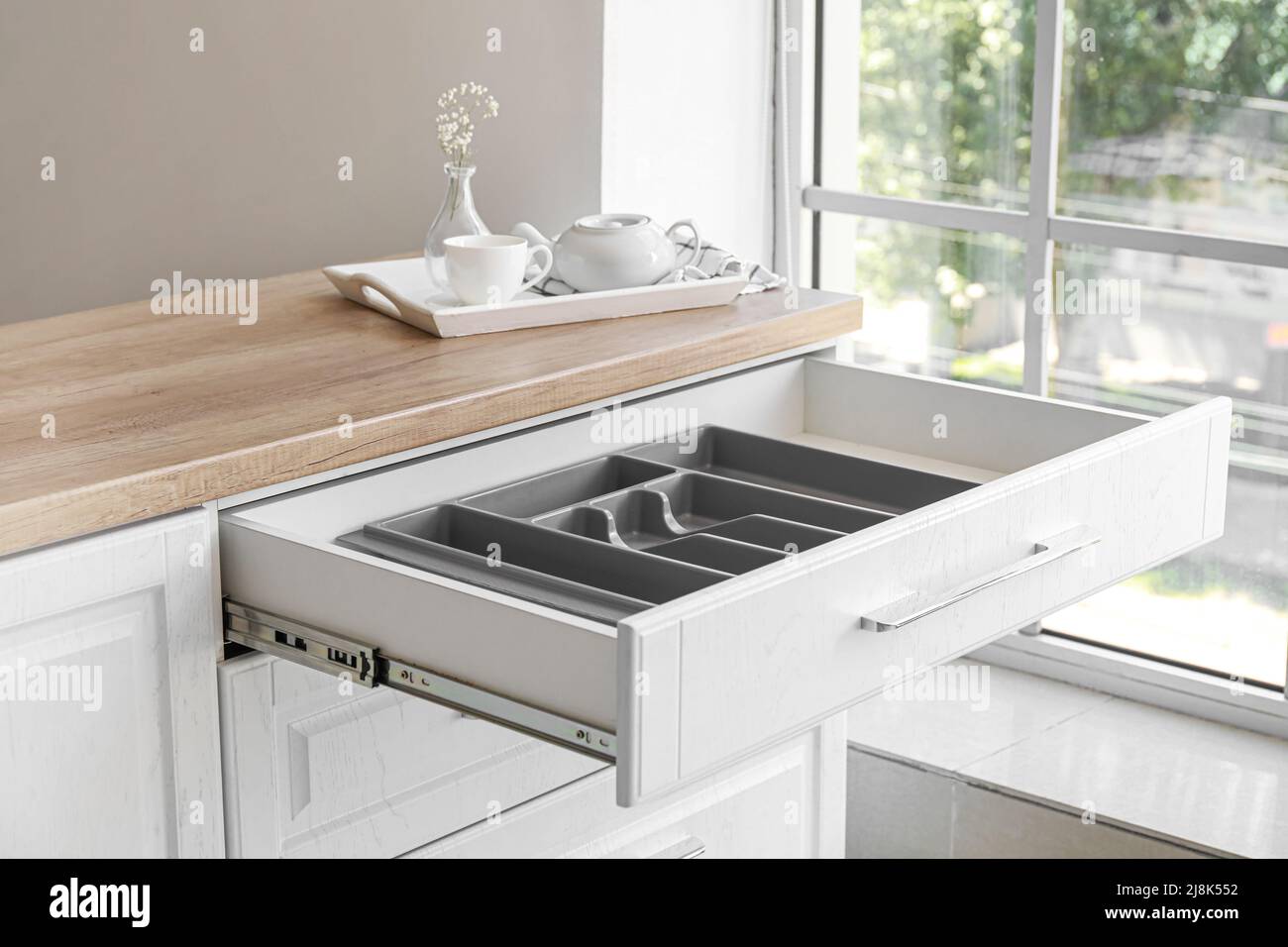 Open empty drawer for cutlery in modern kitchen Stock Photo - Alamy