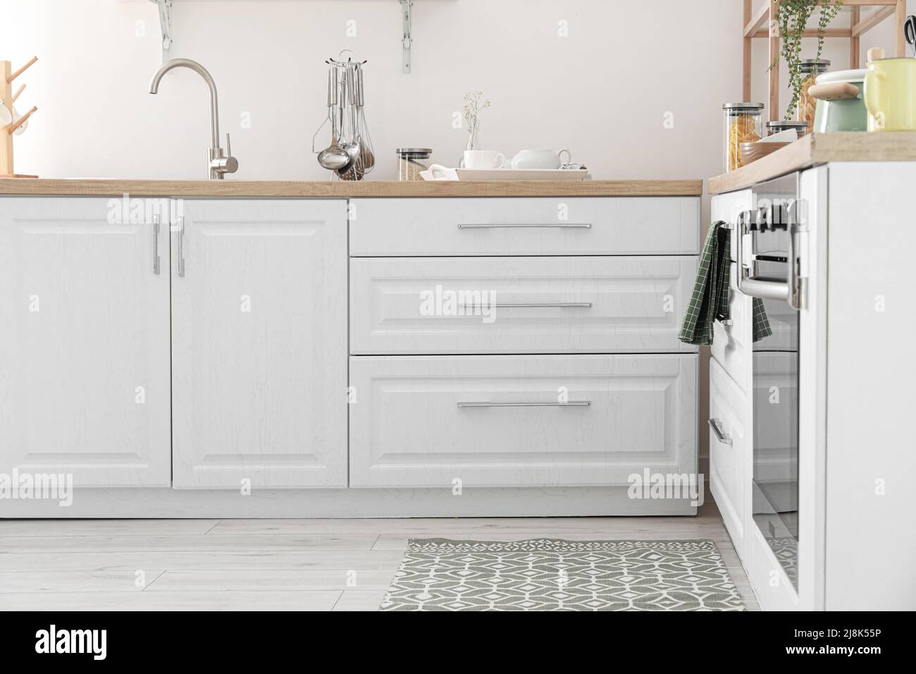 White counters with drawers in modern kitchen Stock Photo - Alamy
