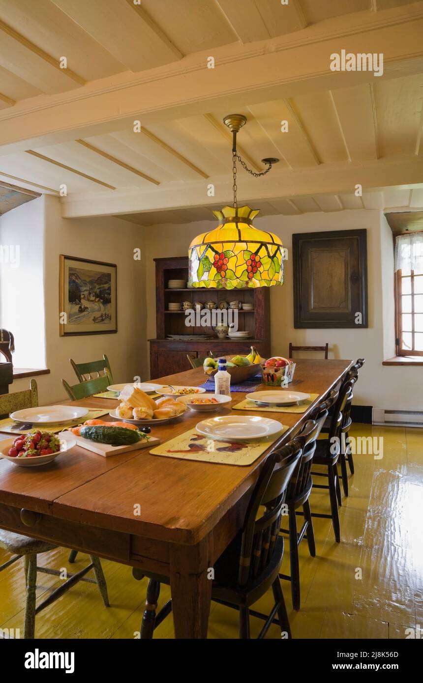 Antique dining table and chairs with lunch set for four in kitchen ...