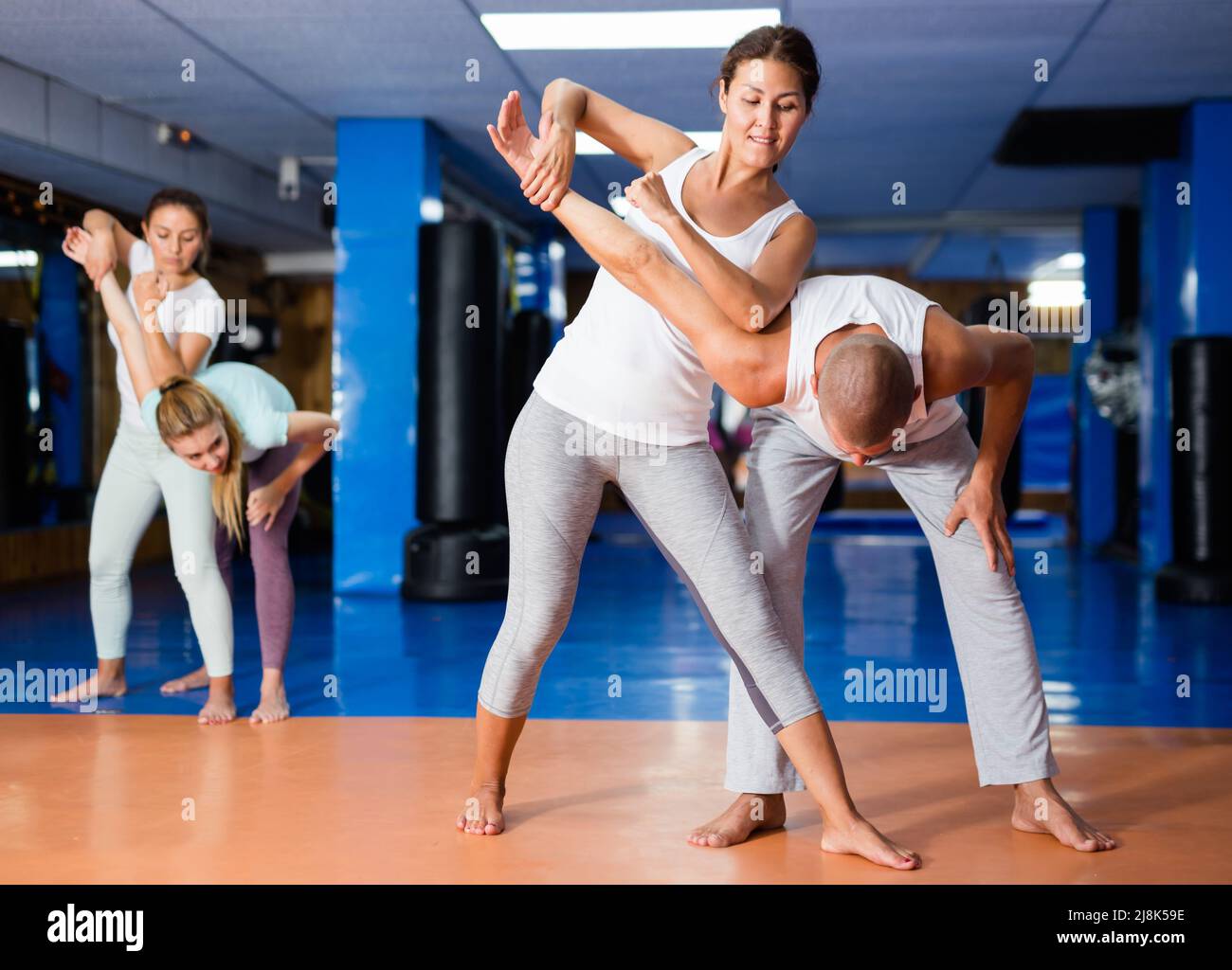 Woman exercising armlock Stock Photo - Alamy