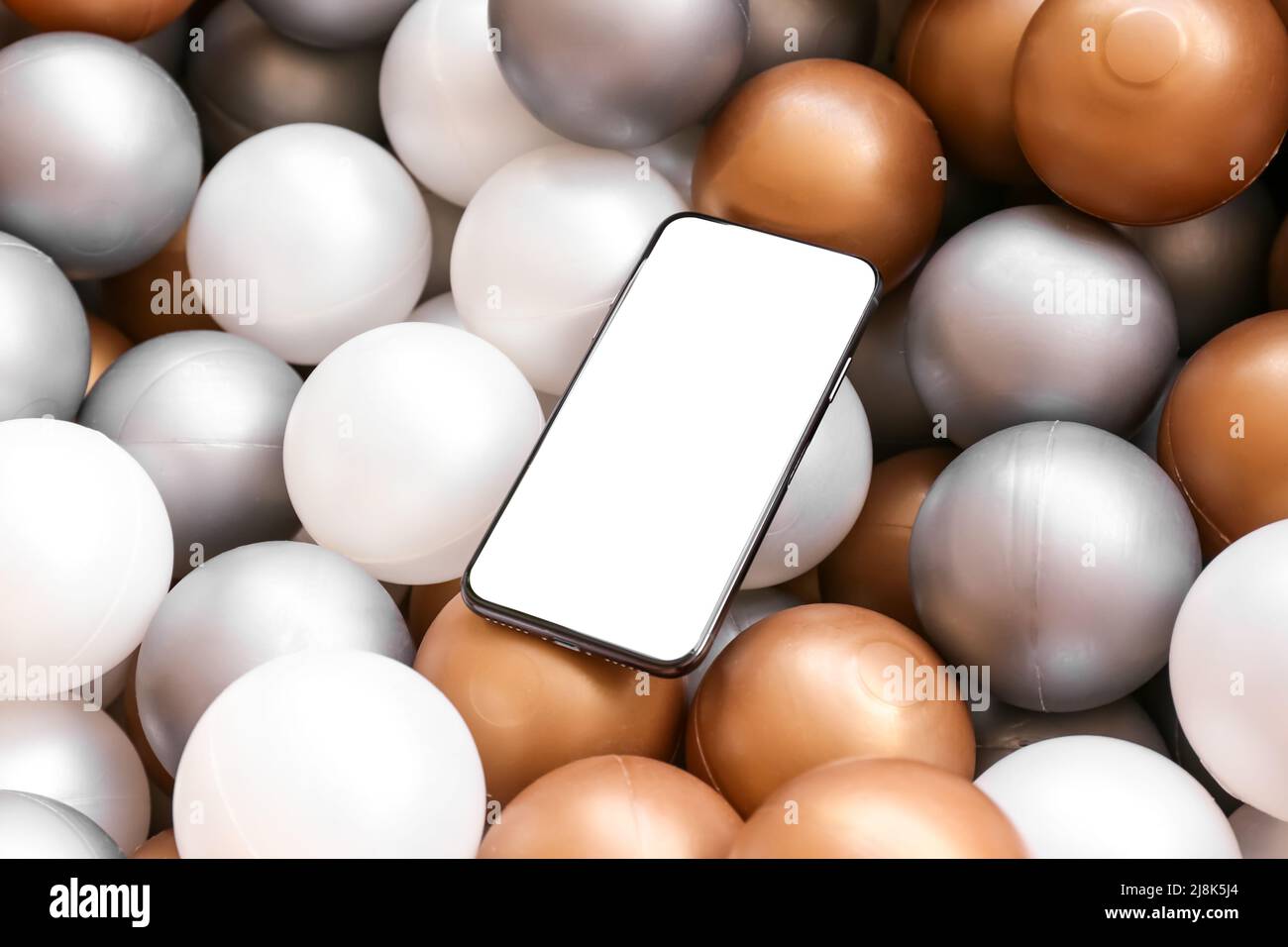 Mobile phone with blank screen on colorful plastic balls Stock Photo ...