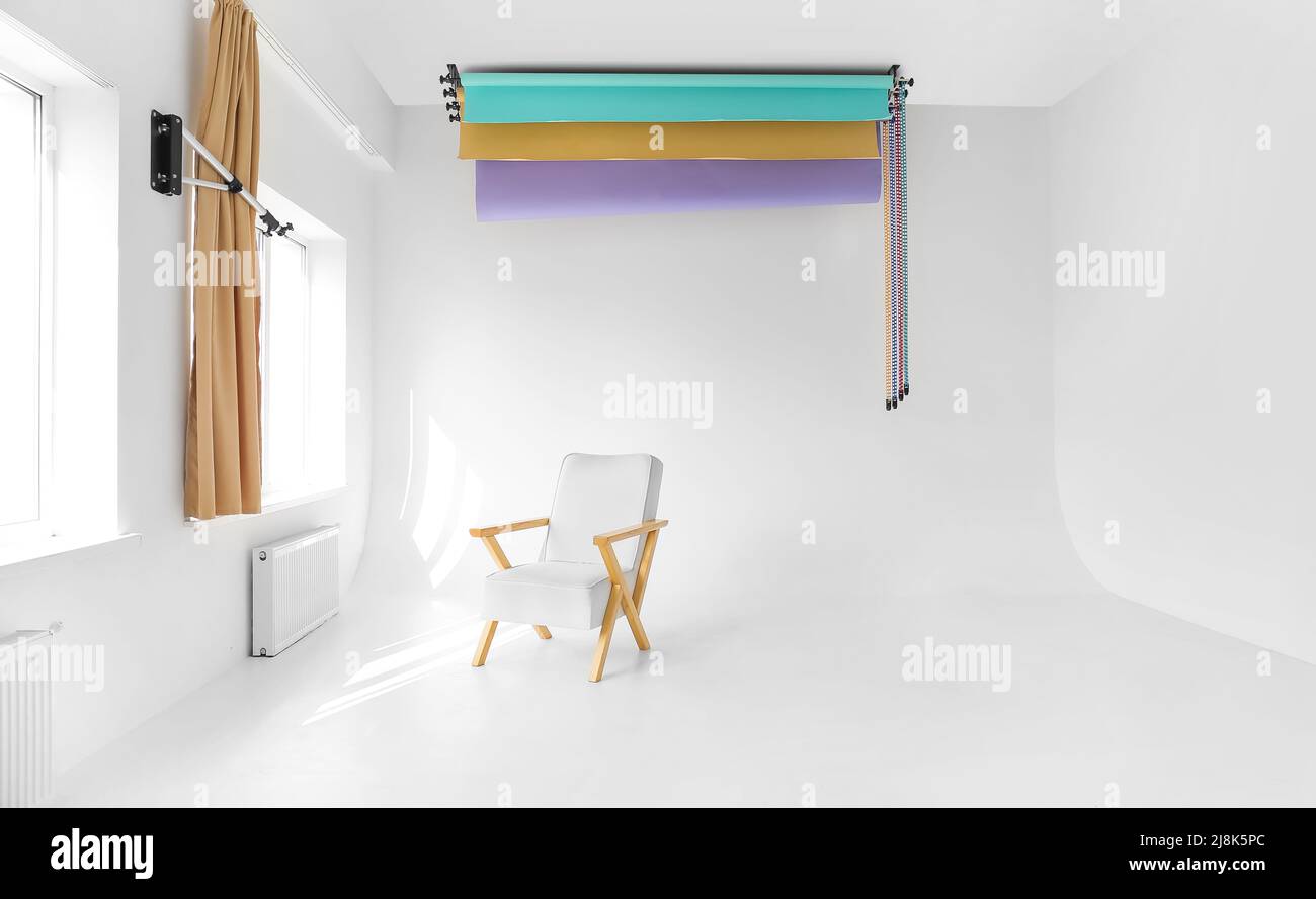 Stylish wooden armchair in modern photo studio Stock Photo - Alamy