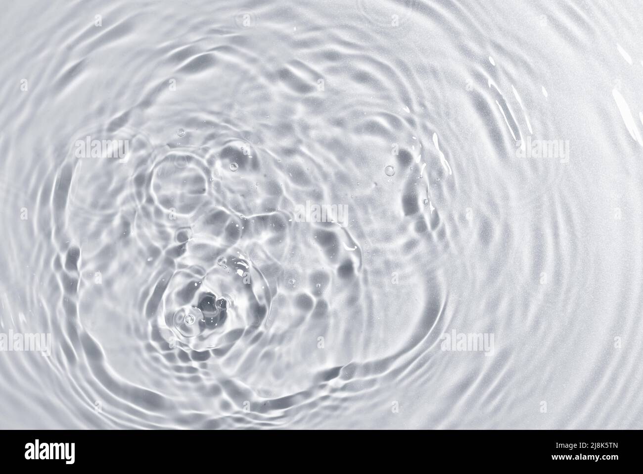 Texture of water with ripples on light background, closeup Stock Photo ...