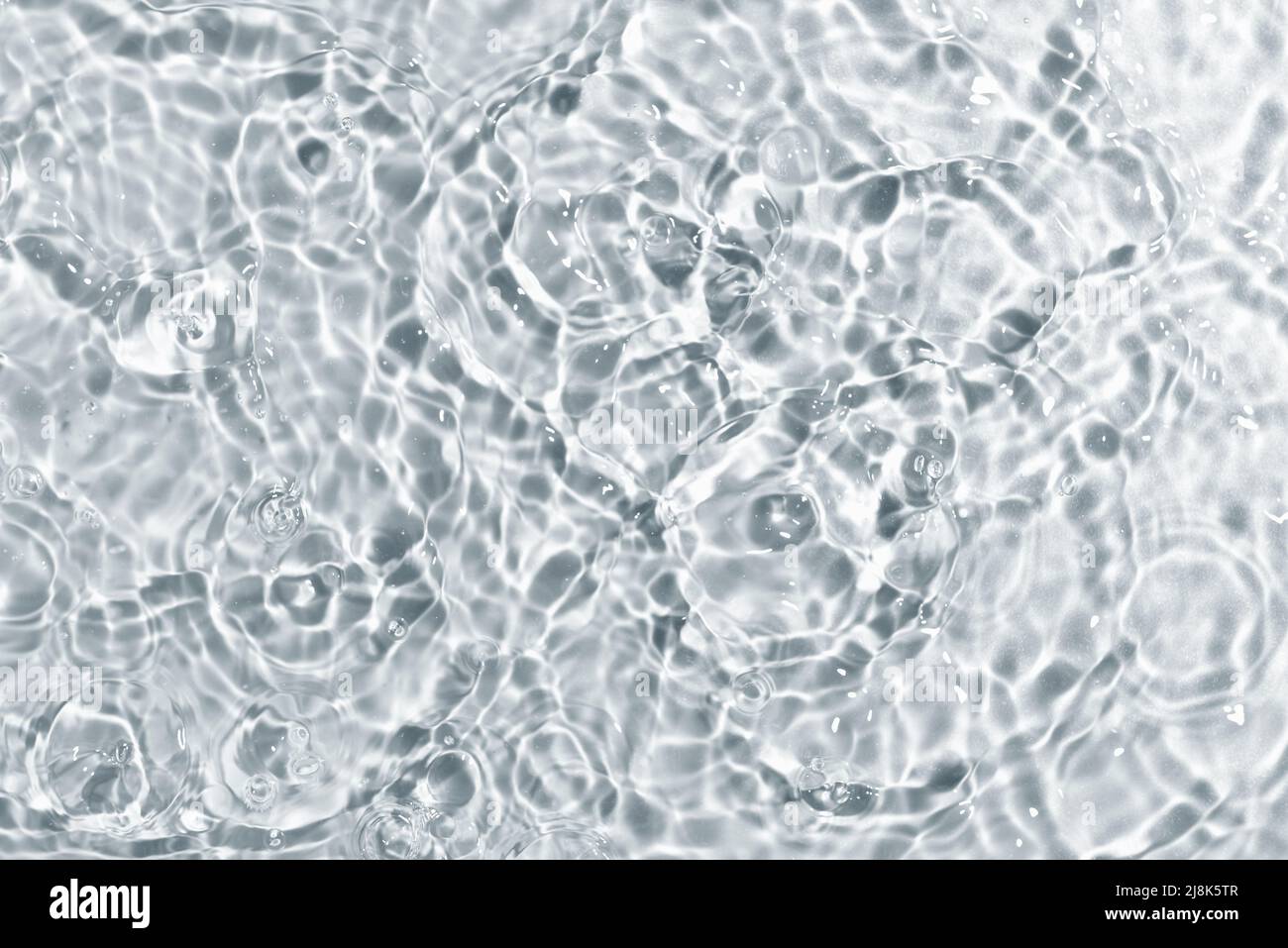 Texture of water with ripples on light background, closeup Stock Photo ...