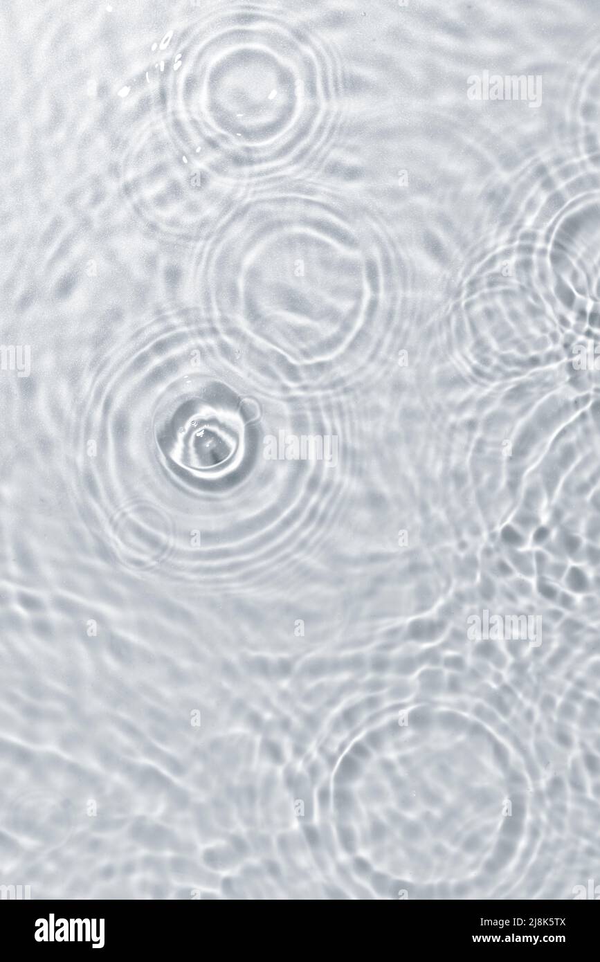 Texture of water with ripples on light background, closeup Stock Photo ...