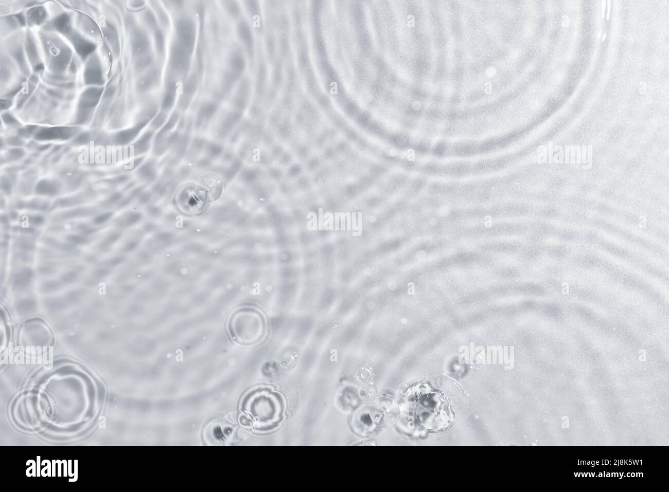 Texture of water with ripples on light background, closeup Stock Photo ...