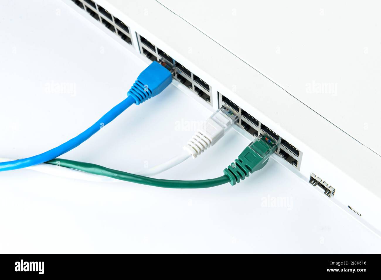 Modern wi-fi router and internet cables isolated on white background ...