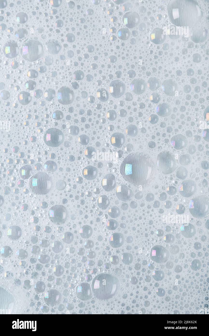 Water with soap foam on grey background Stock Photo - Alamy