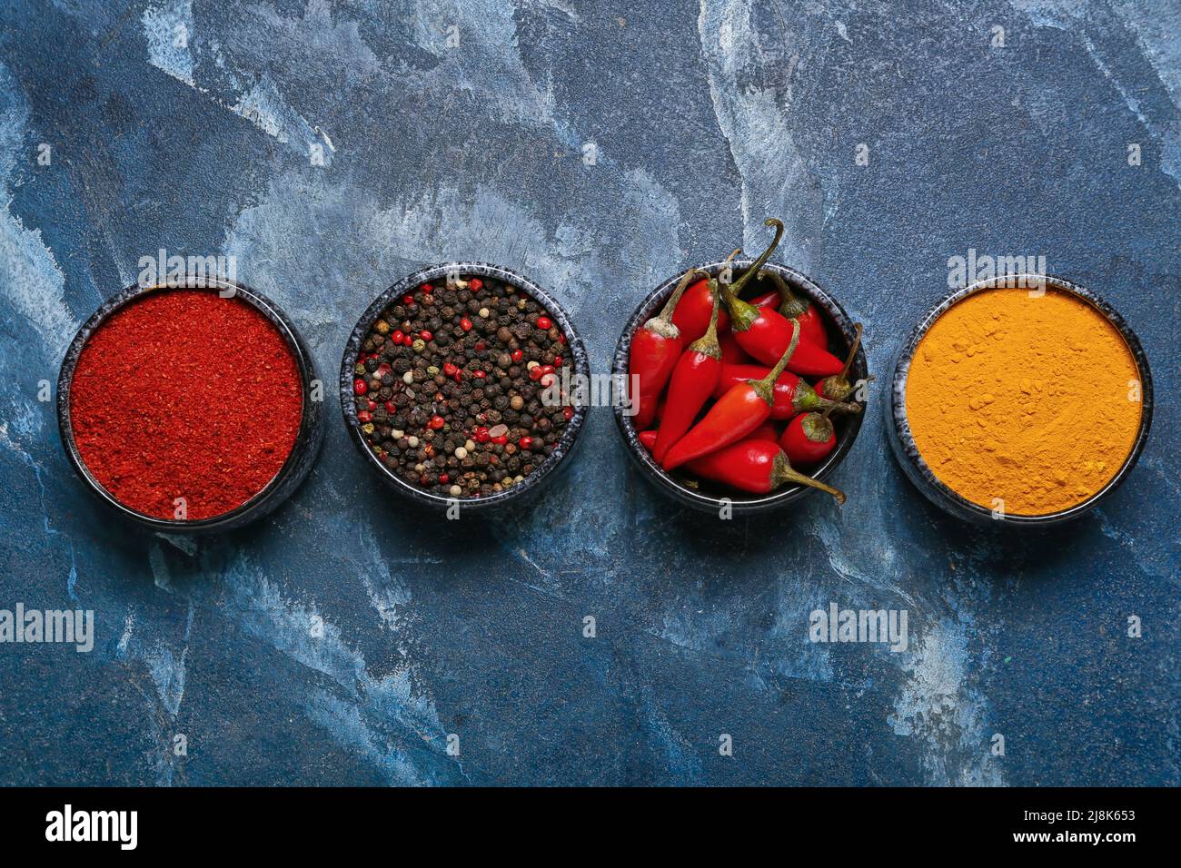 Set of aromatic spices on blue background Stock Photo - Alamy
