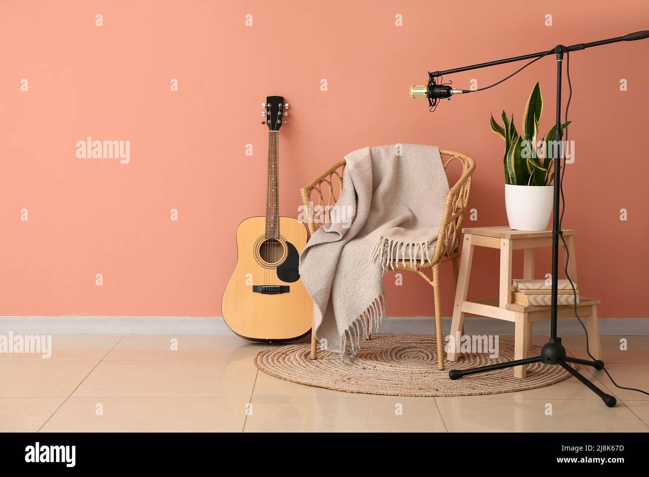 Stand with professional microphone, guitar, chair and stepladder stool ...