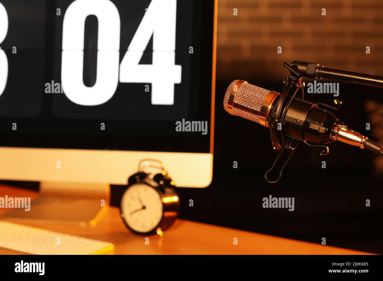 Stand with professional microphone near workplace in room at night ...
