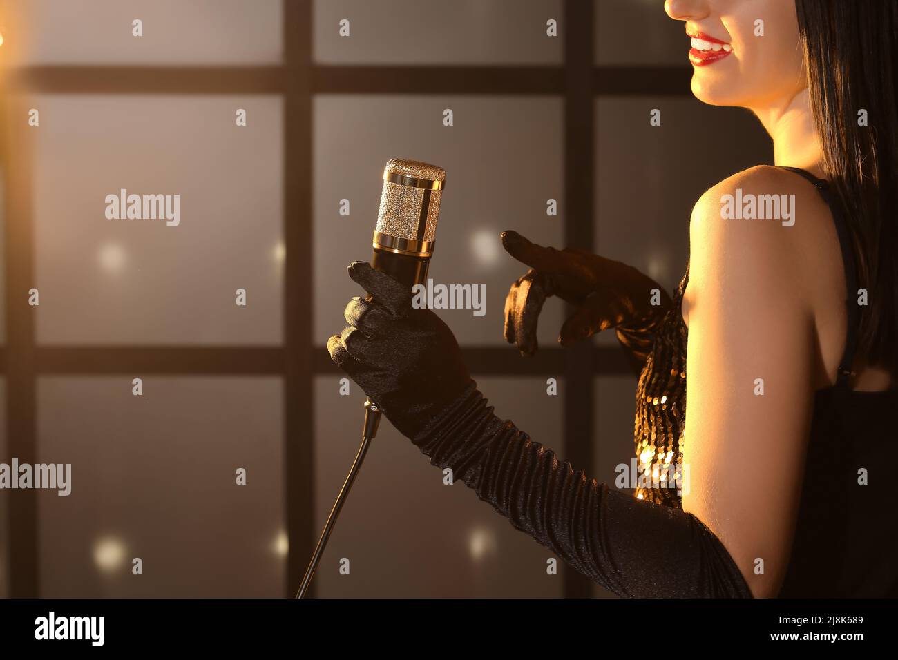 Female singer with microphone performing on stage, closeup Stock Photo ...