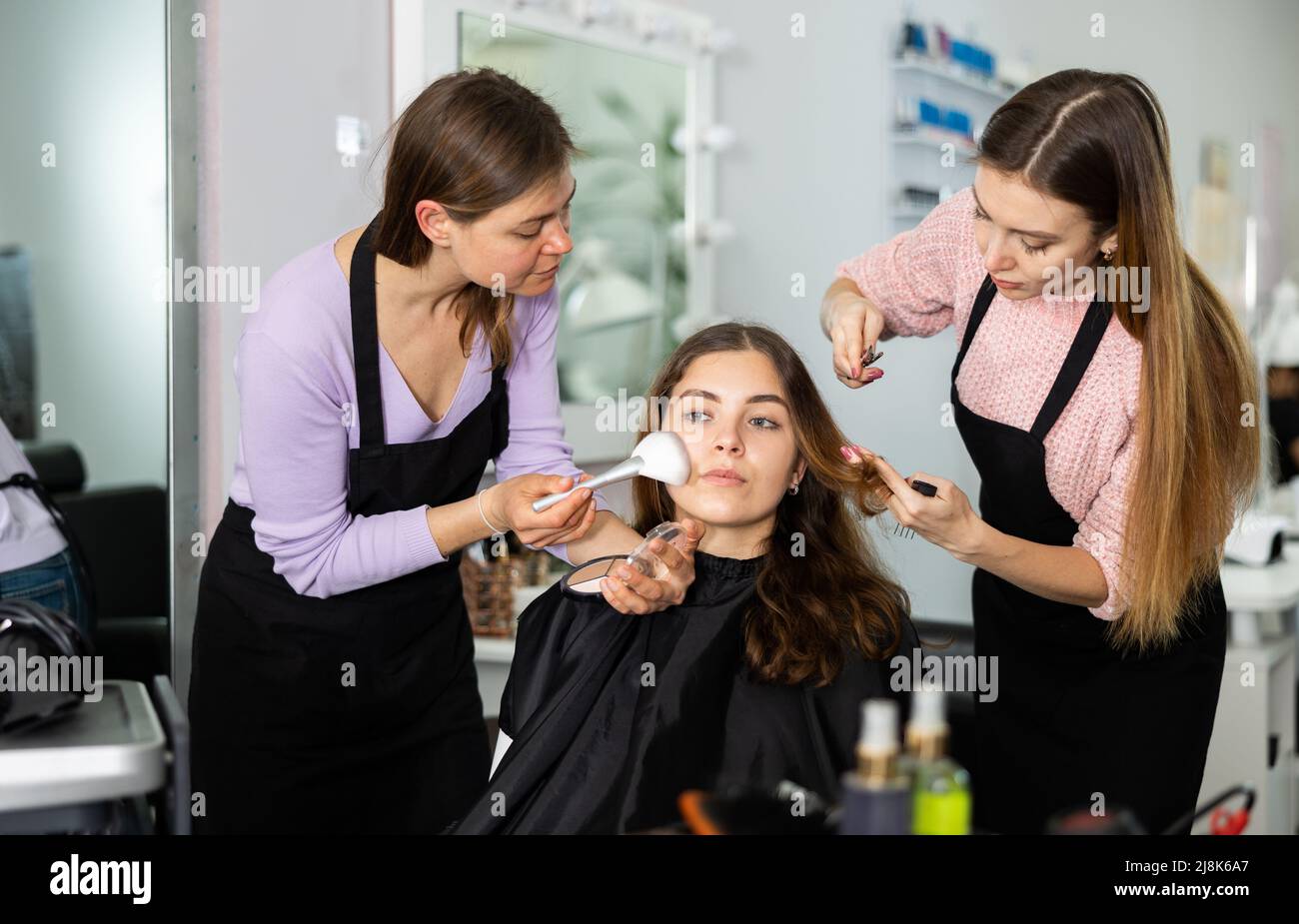 Young woman visiting beauty parlor for hairstyling and makeup Stock ...