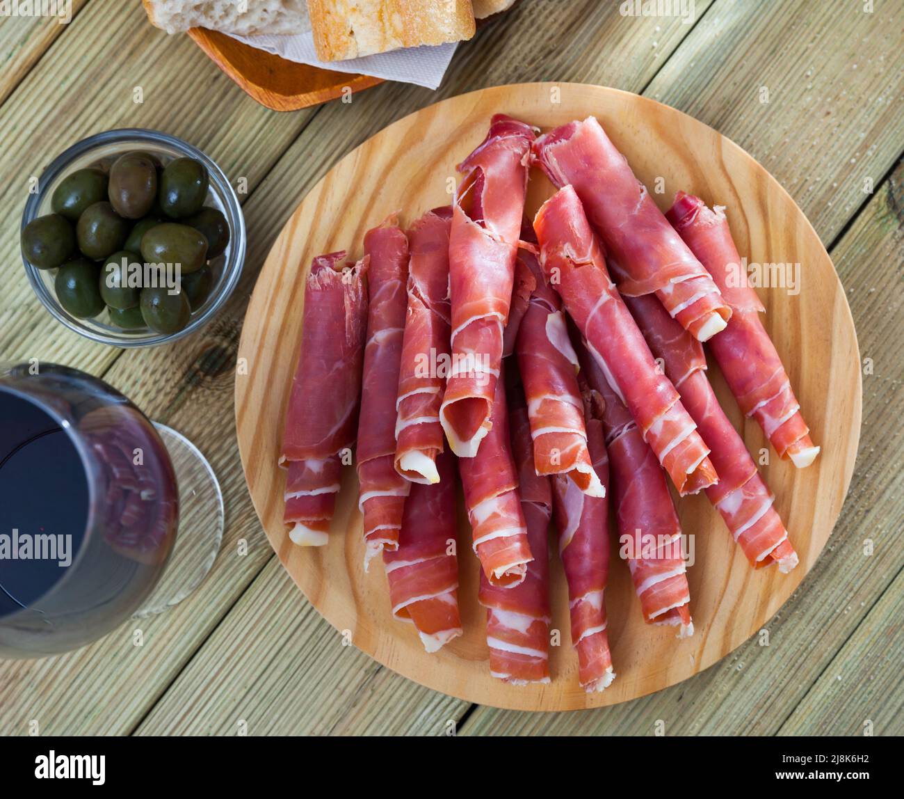 Spanish dry cured jamon on wooden plate Stock Photo - Alamy