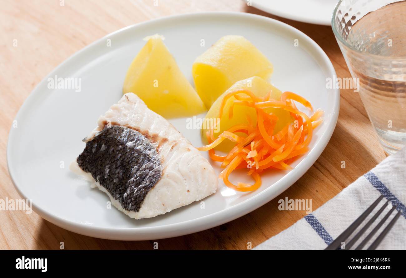 Steamed hake with grated carrot and potatoes Stock Photo - Alamy