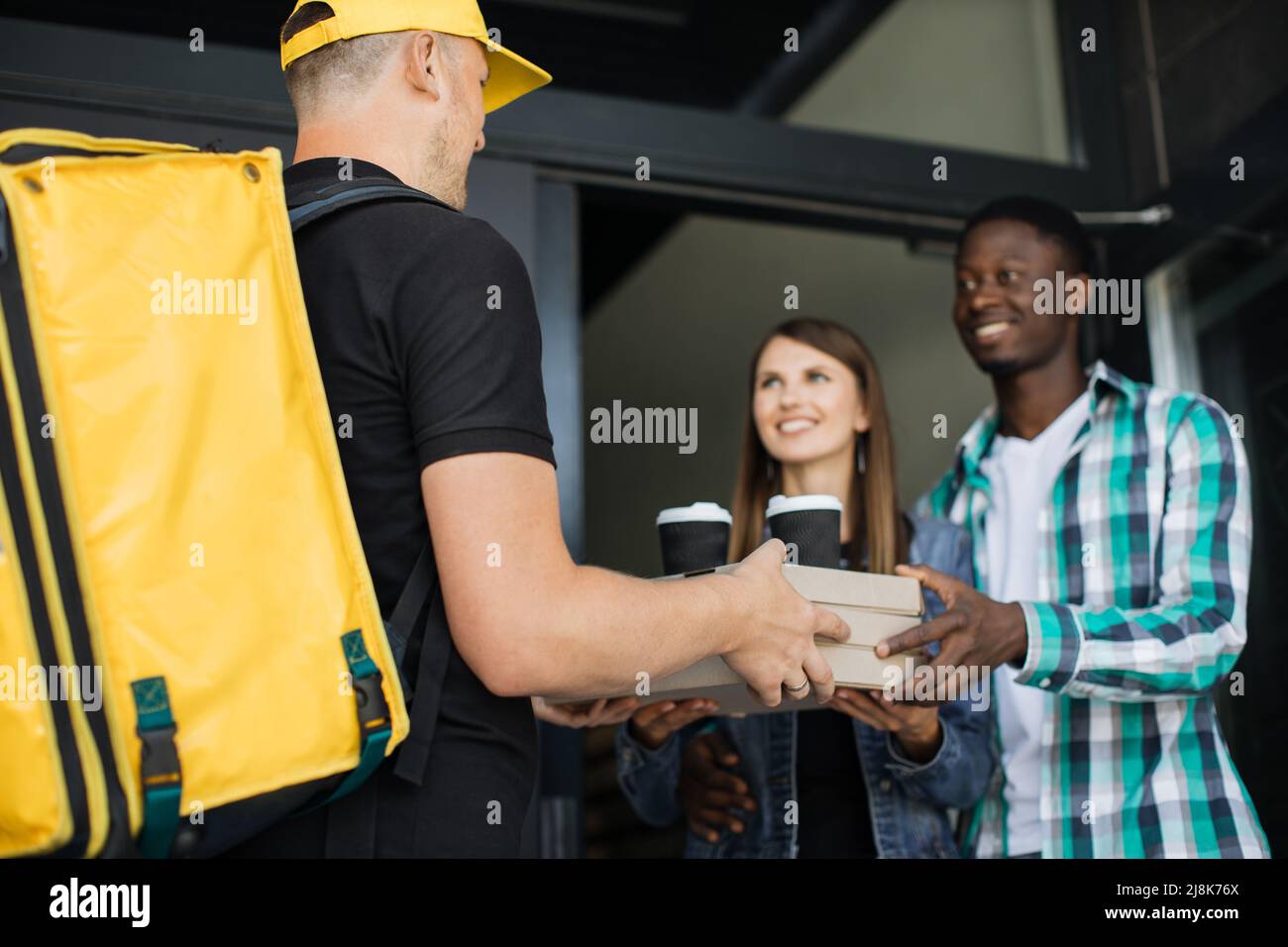 Delivery man with yellow uniform and cap that new normal style by ...