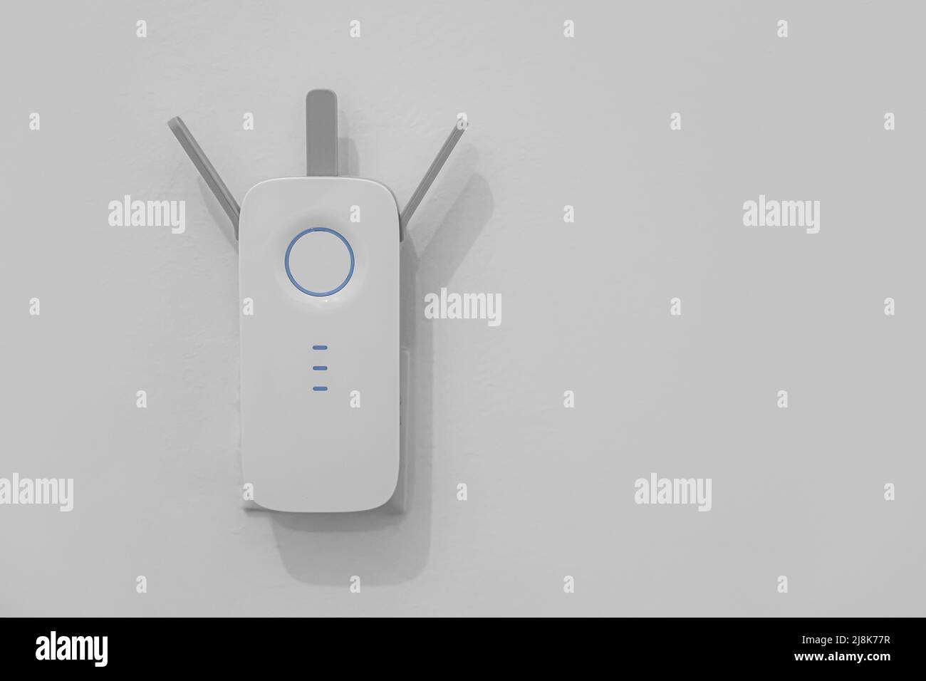 Modern wi-fi router hanging on light wall Stock Photo - Alamy