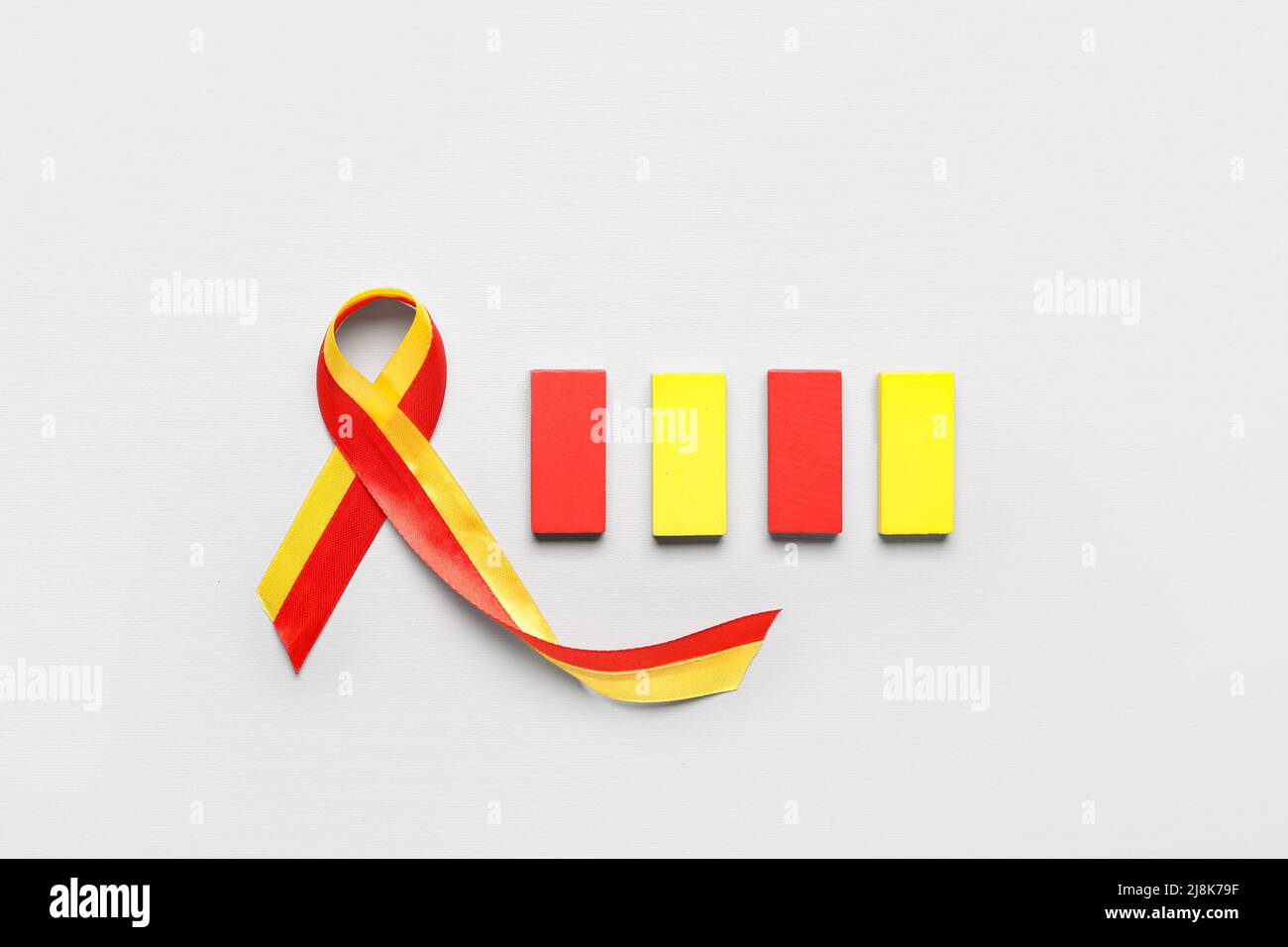 Awareness ribbon with blocks on light background. Hepatitis concept ...