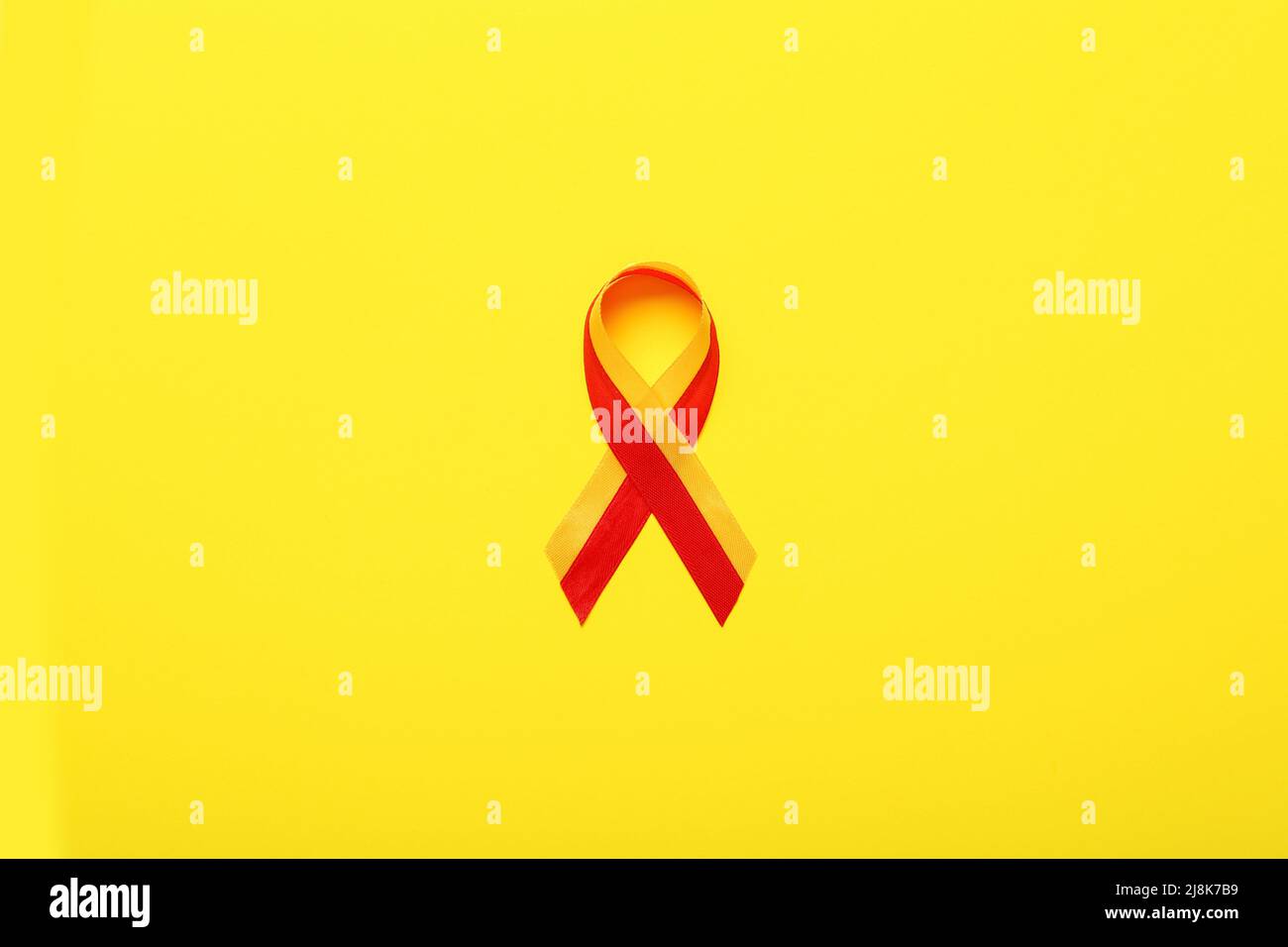 Awareness ribbon on yellow background. Hepatitis concept Stock Photo ...