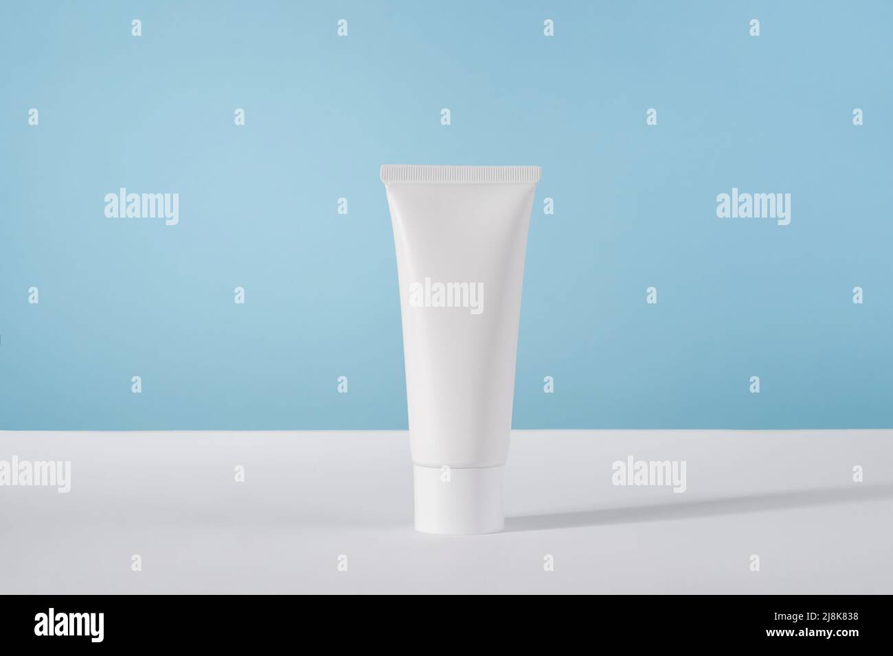 Moisturiser hand cosmetic cream white plastic tube mockup on blue ...