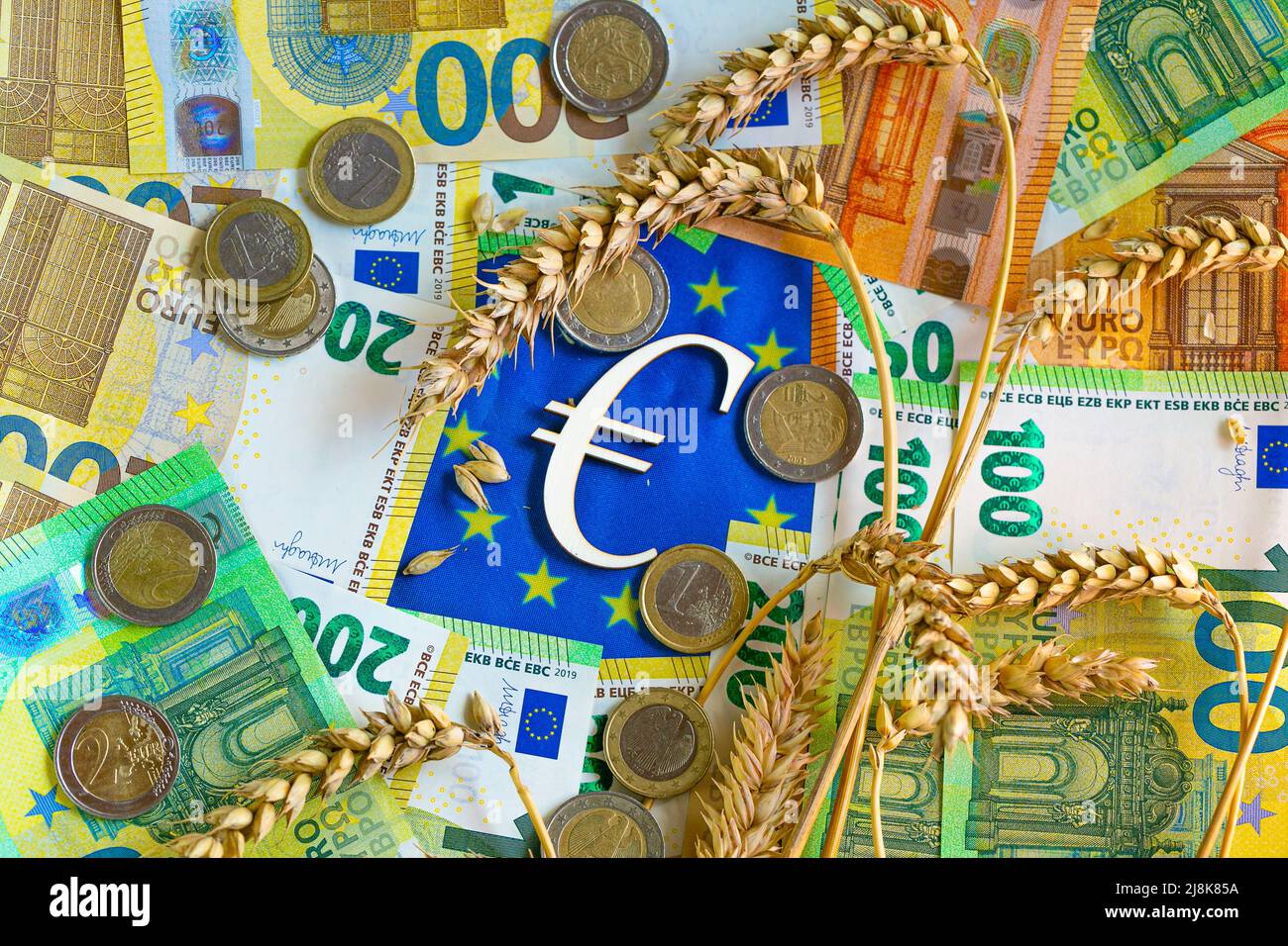 Euro coins and Grains of wheat on the flag of the EU.Prices for wheat ...