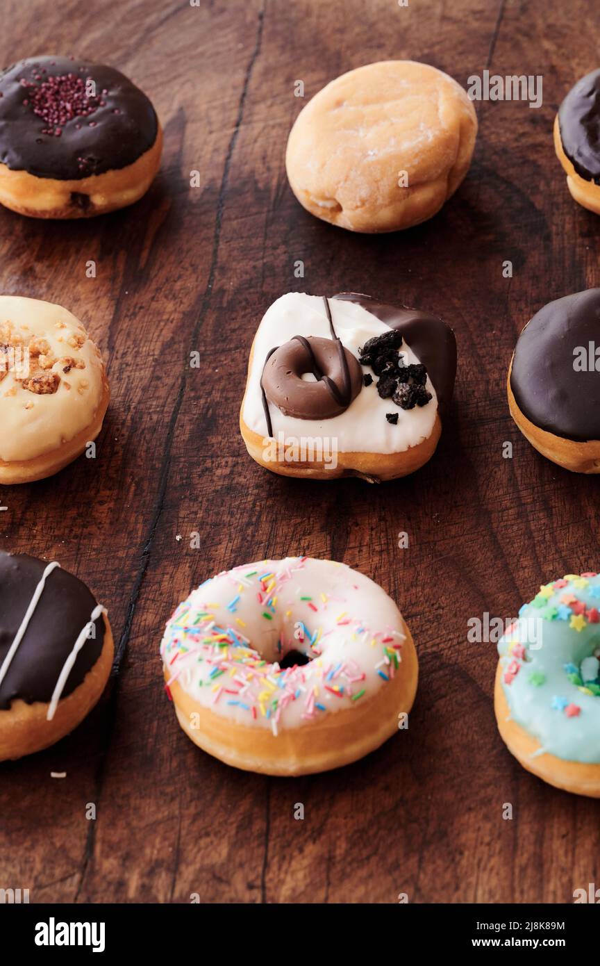 Delicious iced donuts on a wooden board ready to be eaten Stock Photo ...